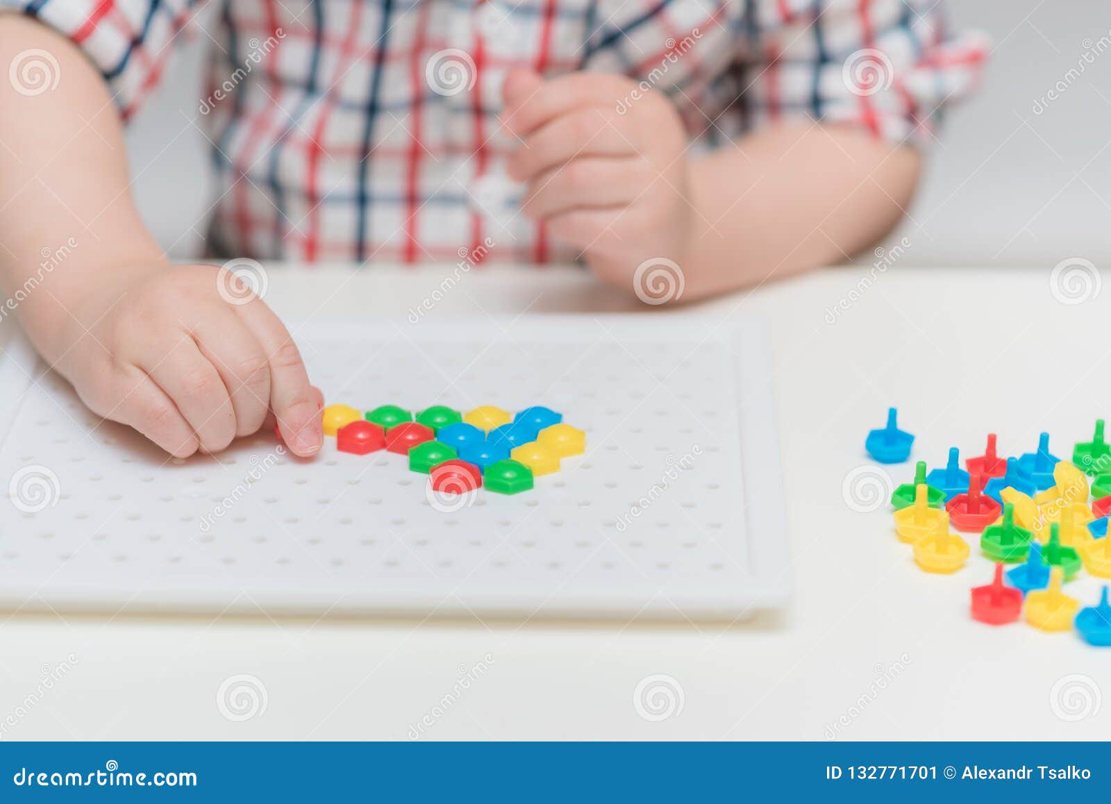 The Baby Plays with a Mosaic Sitting at a Table Stock Image - Image of ...