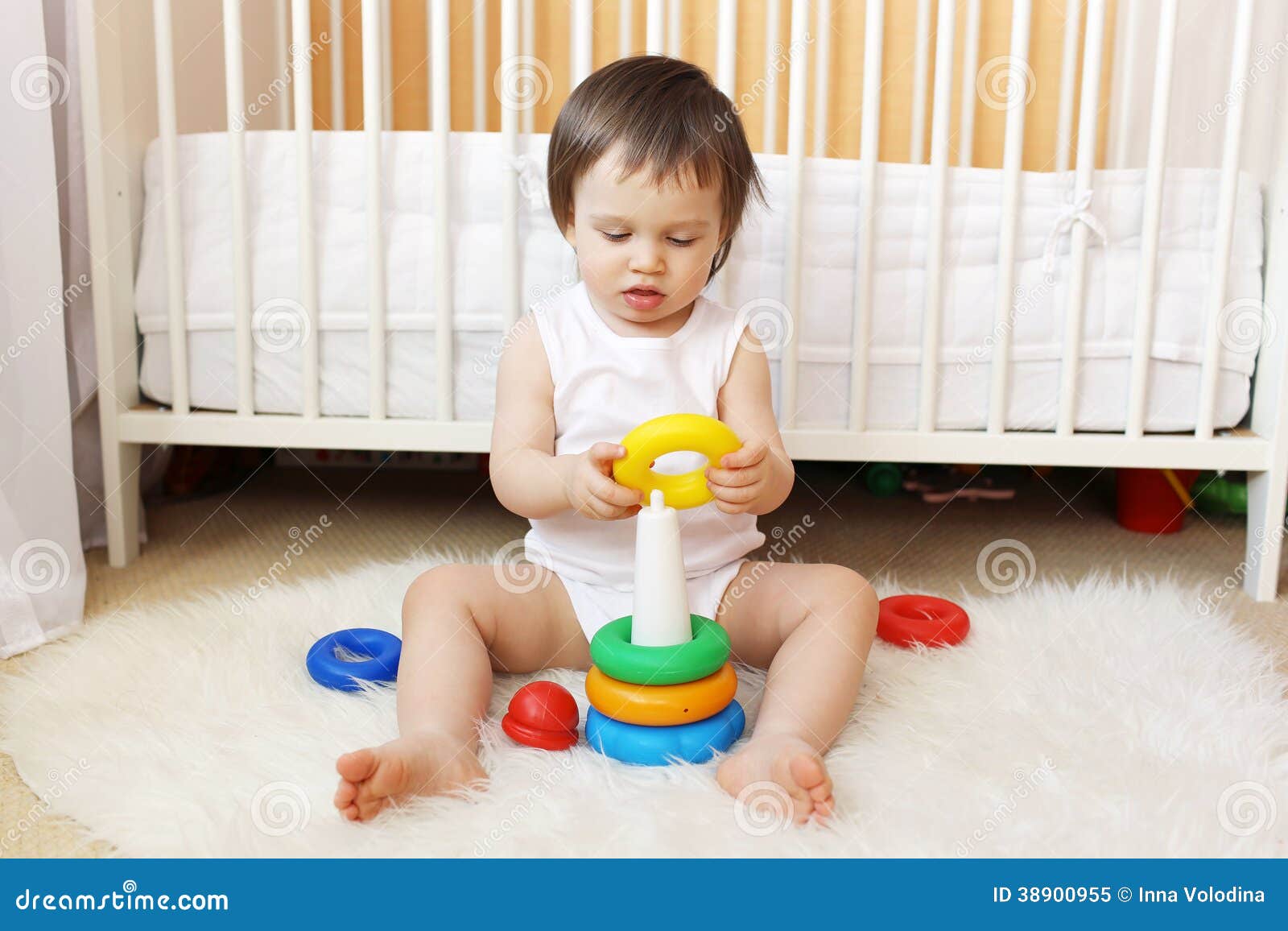 Baby plays nesting blocks stock image. Image of year - 38900955