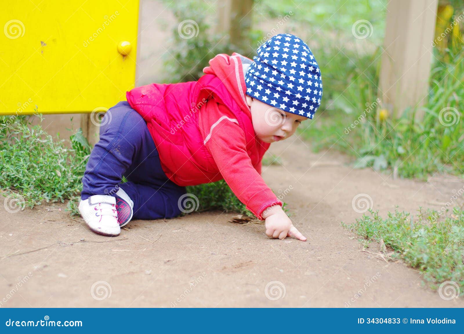 Baby Points Something Sitting on the Ground on Playground Stock Image ...