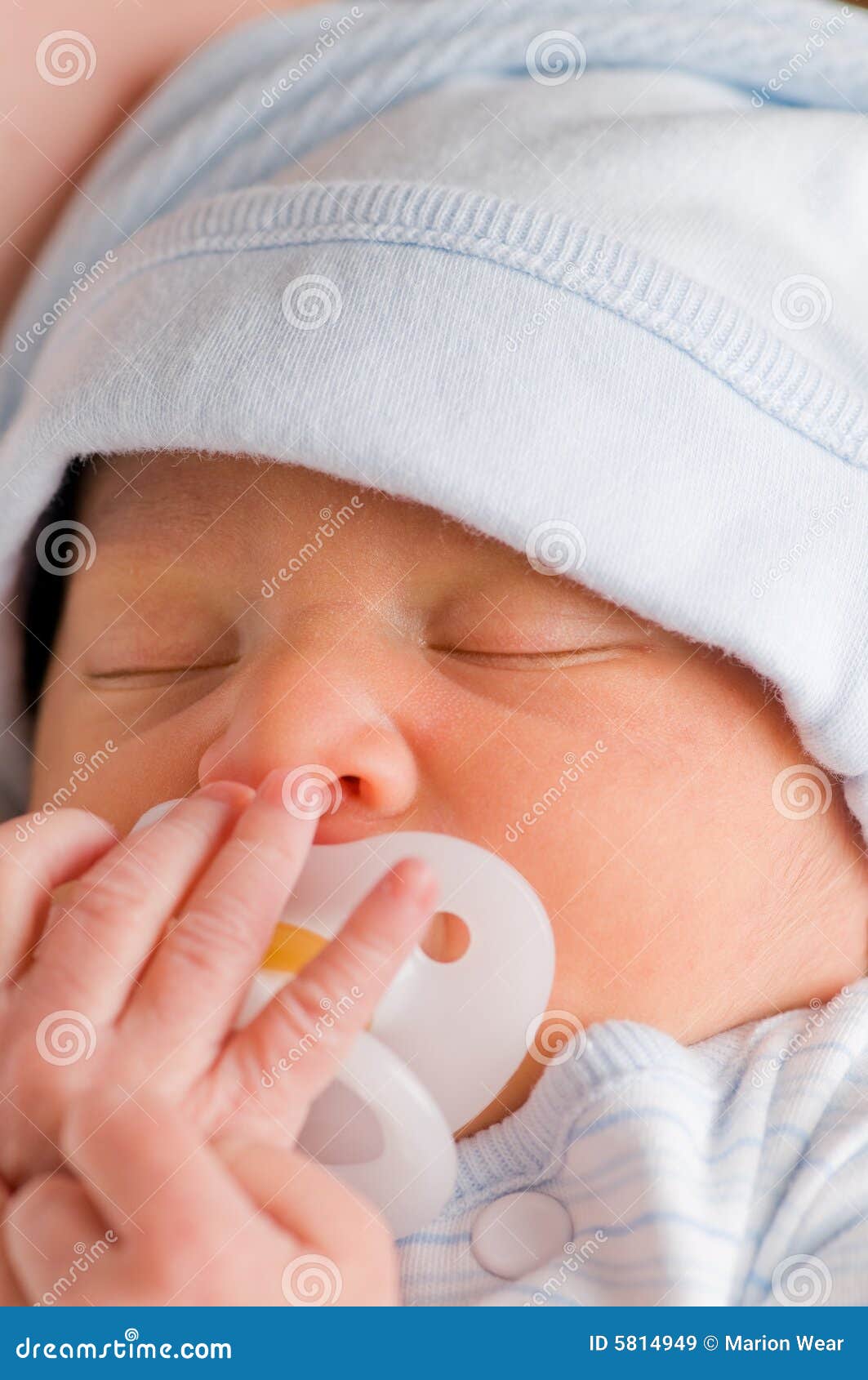 Baby protects his pacifier stock image. Image of newborn - 5814949
