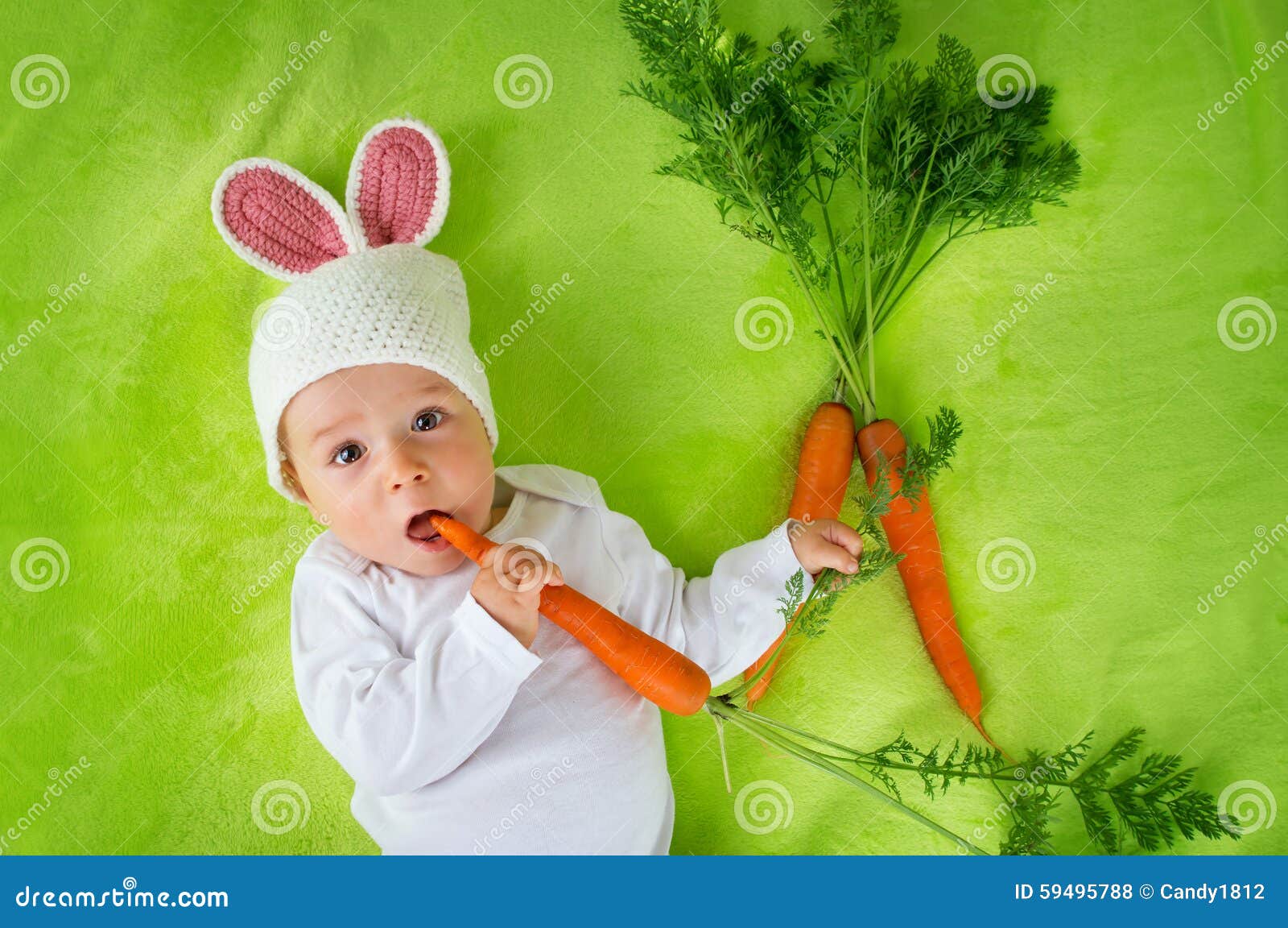 Baby in Rabbit Hat Eating Carrot Stock Photo - Image of holding, carrot ...