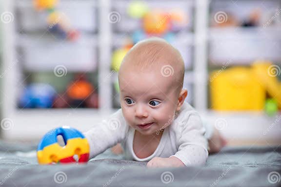 Baby Reaching for Toy. Baby Development Stock Photo - Image of innocent ...