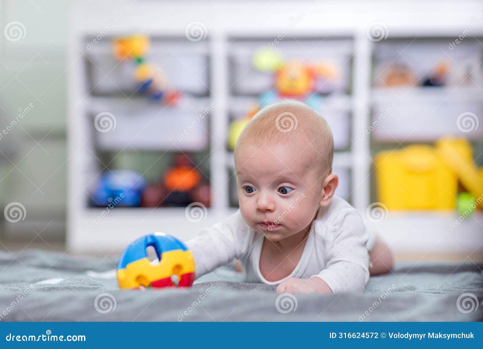 Baby Reaching for Toy. Baby Development Stock Photo - Image of baby ...