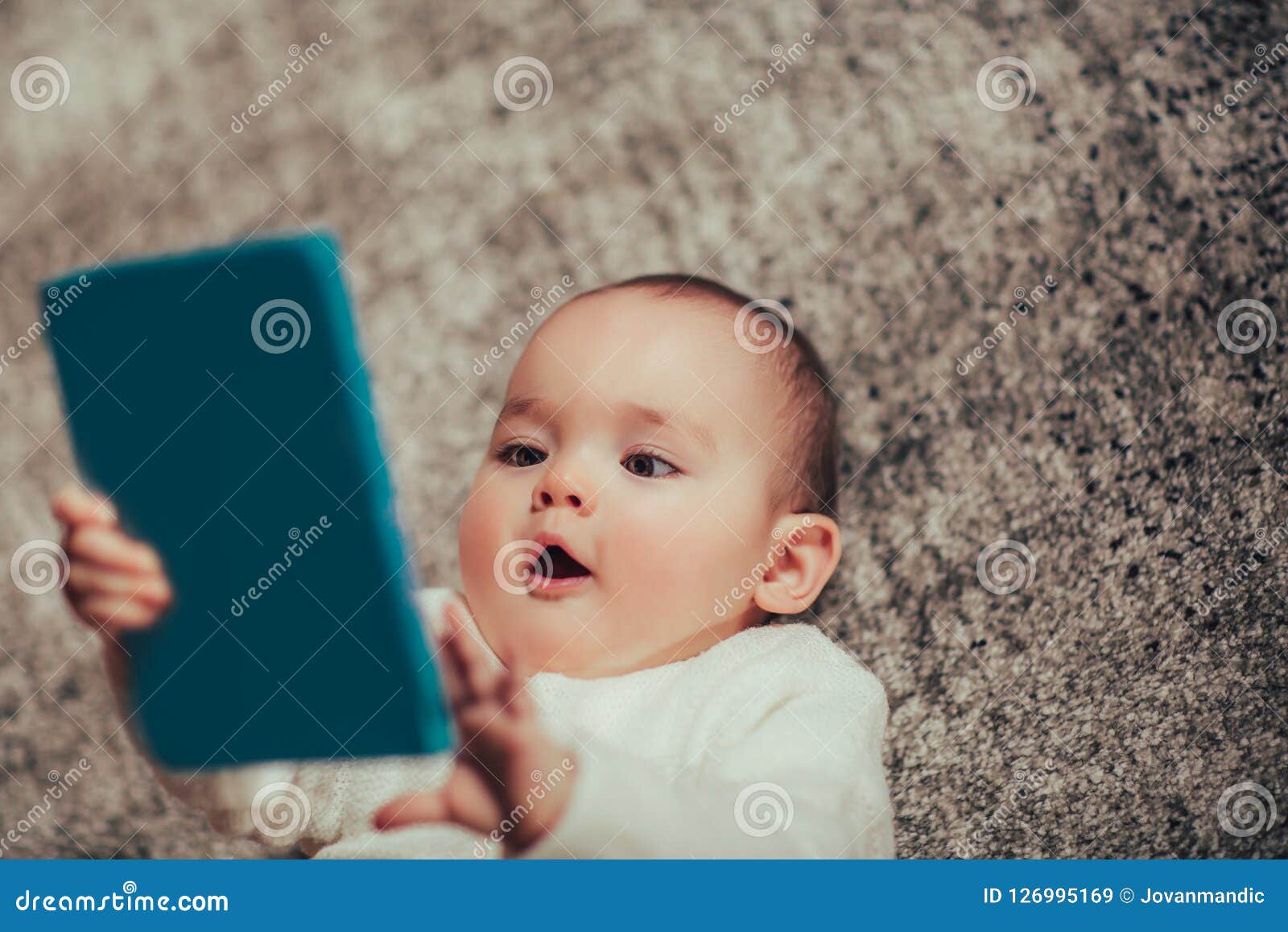Baby Reading a Book on Back Stock Image - Image of cute, funny: 126995169