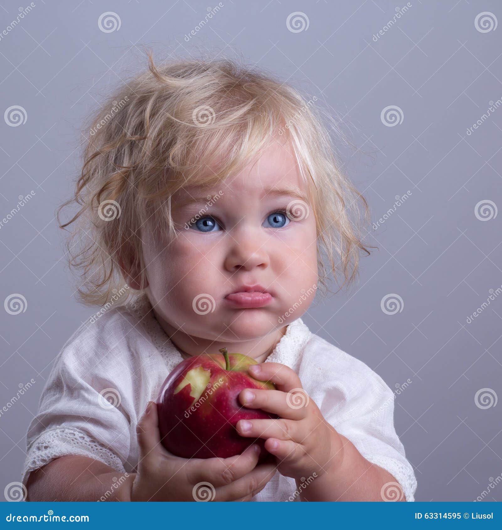 Baby a red apple stock image. Image of affectionate, blond - 63314595