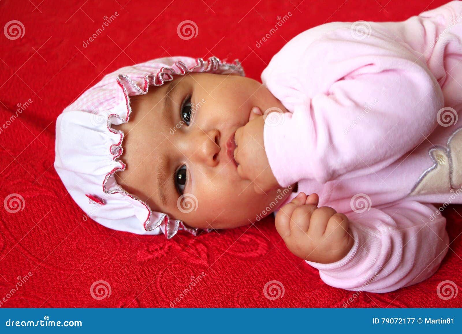 Baby on red bed stock image. Image of small, relaxation - 79072177