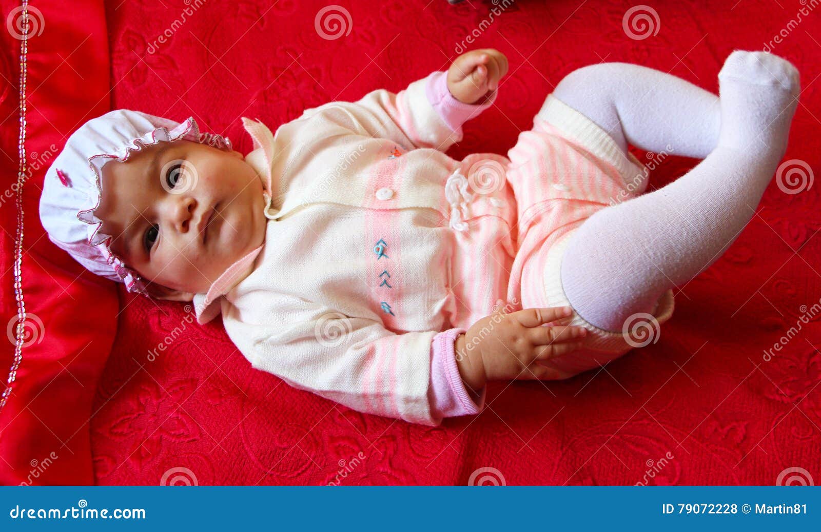 Baby on red bed stock photo. Image of jacket, scene, positivity - 79072228