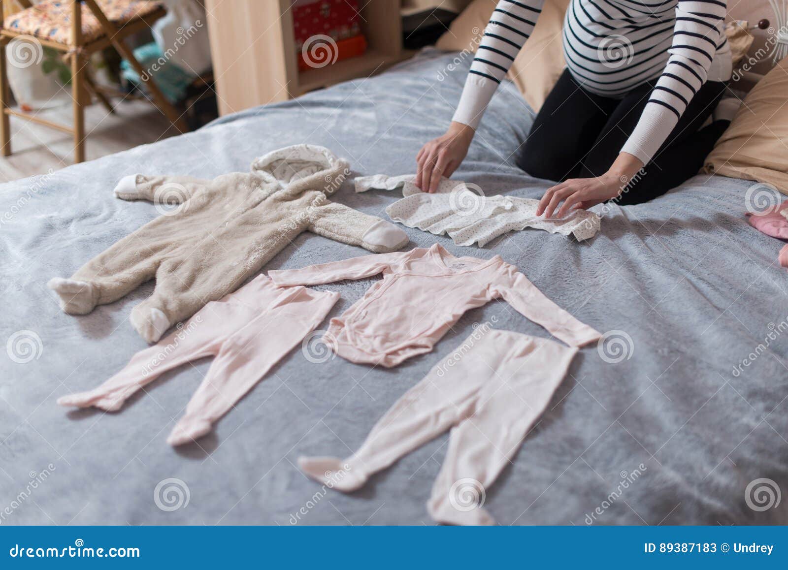 Baby`s Clothes Laid Out on Bed, Natural Light. Stock Image - Image of ...