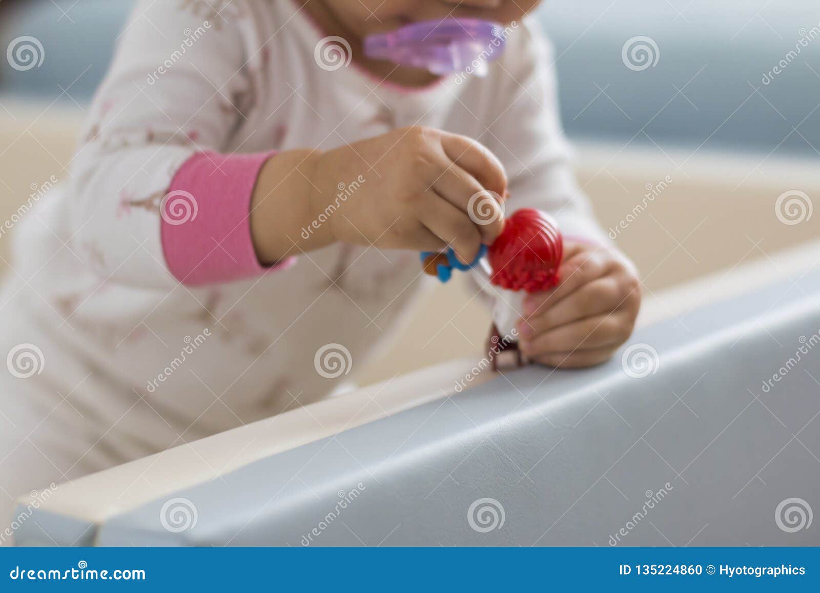 A Baby`s Hand Holding a Toy Stock Photo - Image of pink, baby: 135224860