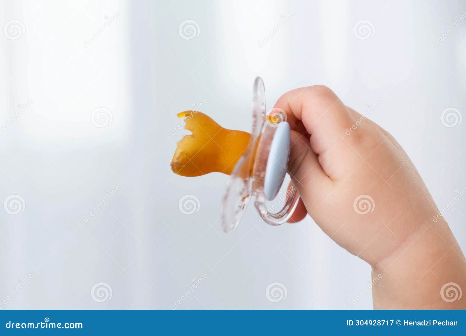A Baby& X27;s Pacifier is Chewed and Torn in a Baby& X27;s Hand, Close ...