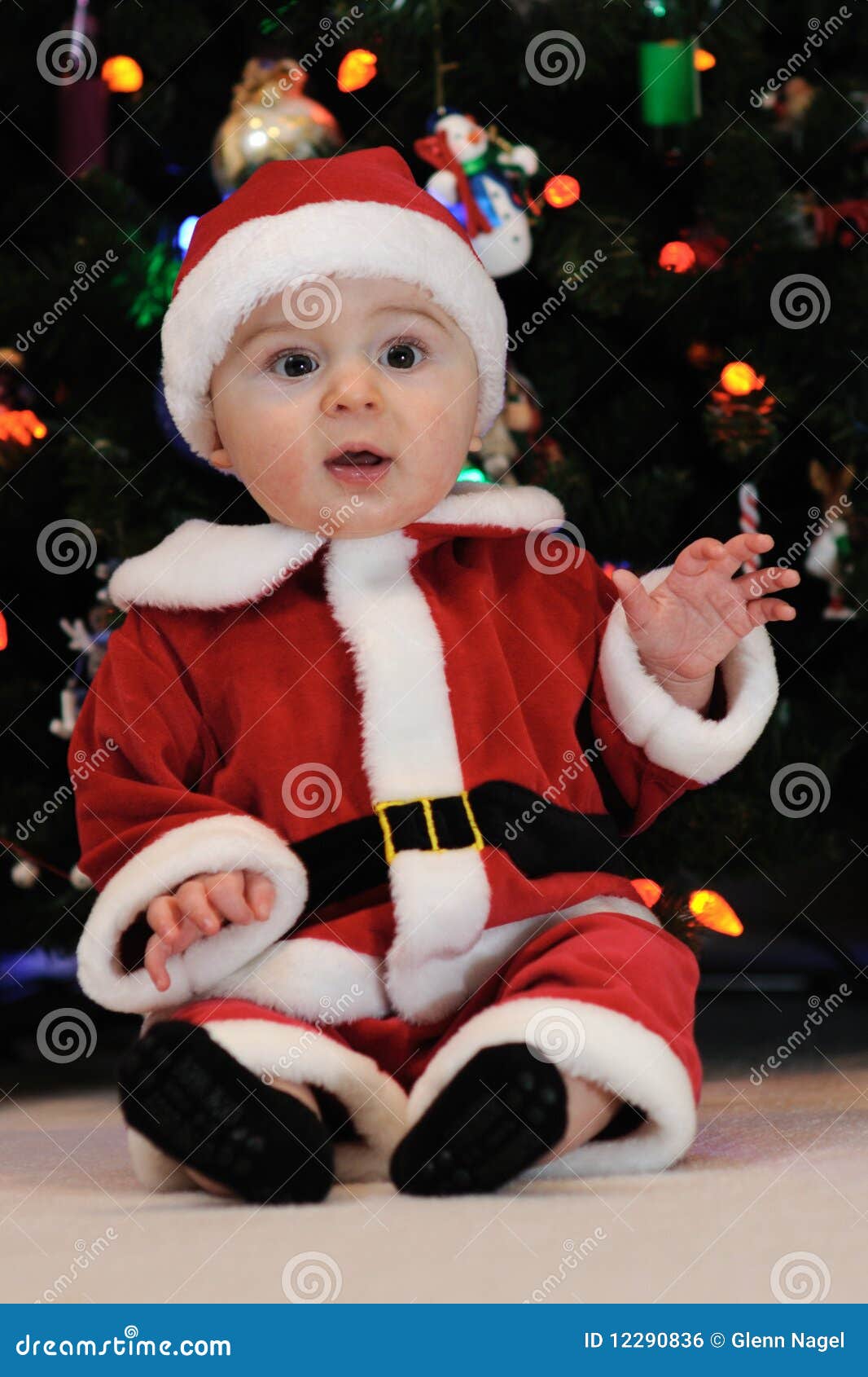 Baby In Santa Outfit Looking Over Shoulder At Camera Stock Photography ...