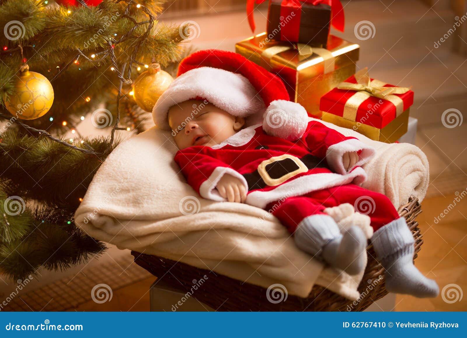 Baby Santa Sleeping Under Christmas Tree with Presents Stock Photo ...