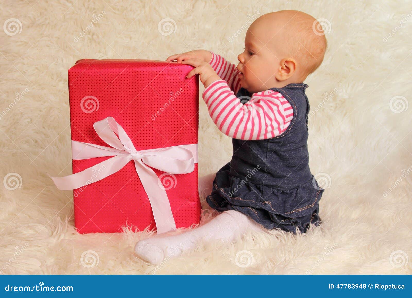 Baby sitting besid a gift stock photo. Image of child - 47783948