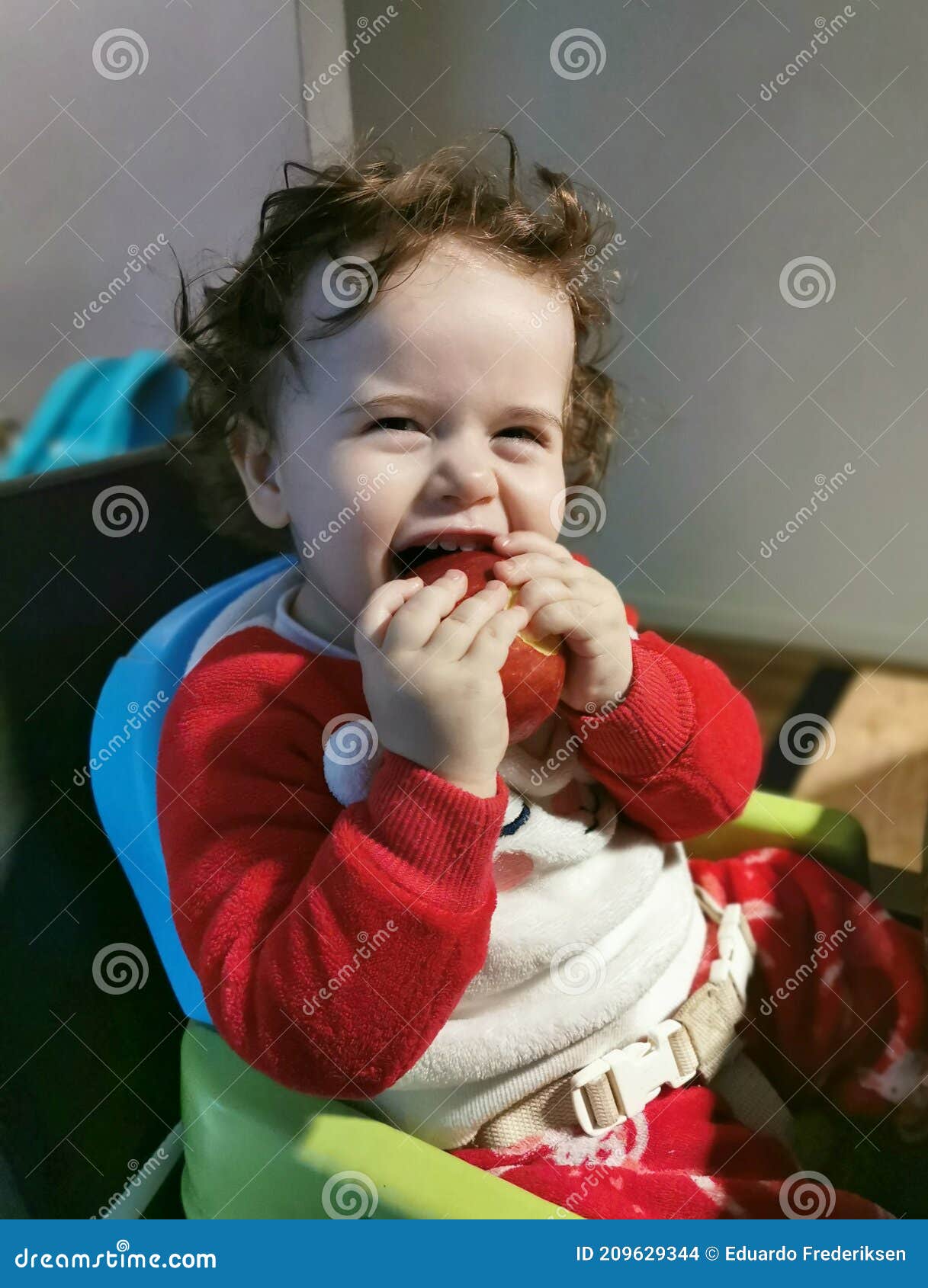 Baby Sitting in Baby Chair Eating an Apple Alone Stock Photo - Image of ...