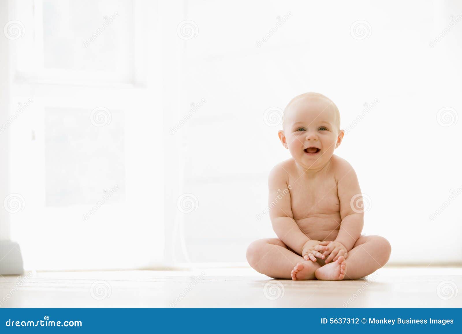 Baby Sitting In Baby Chair And Making Funny Face Royalty-Free Stock ...