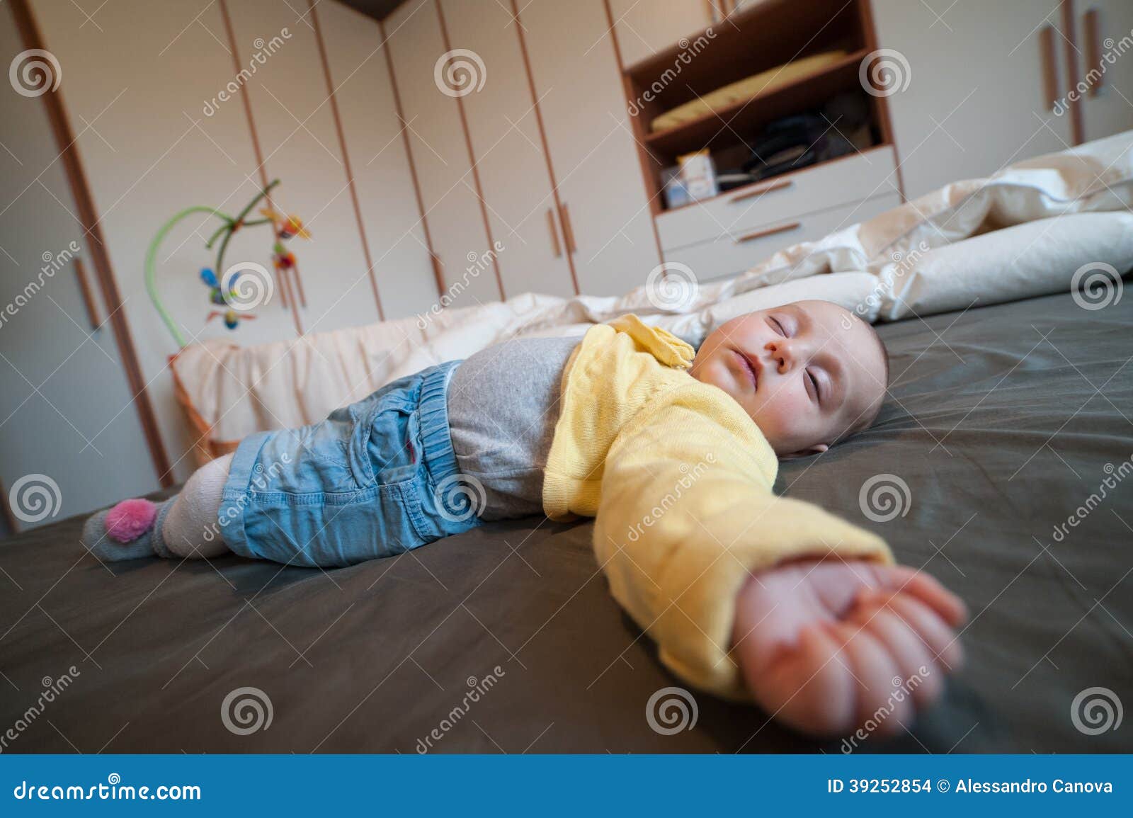 A baby sleeps in the bed stock photo. Image of home, supine - 39252854