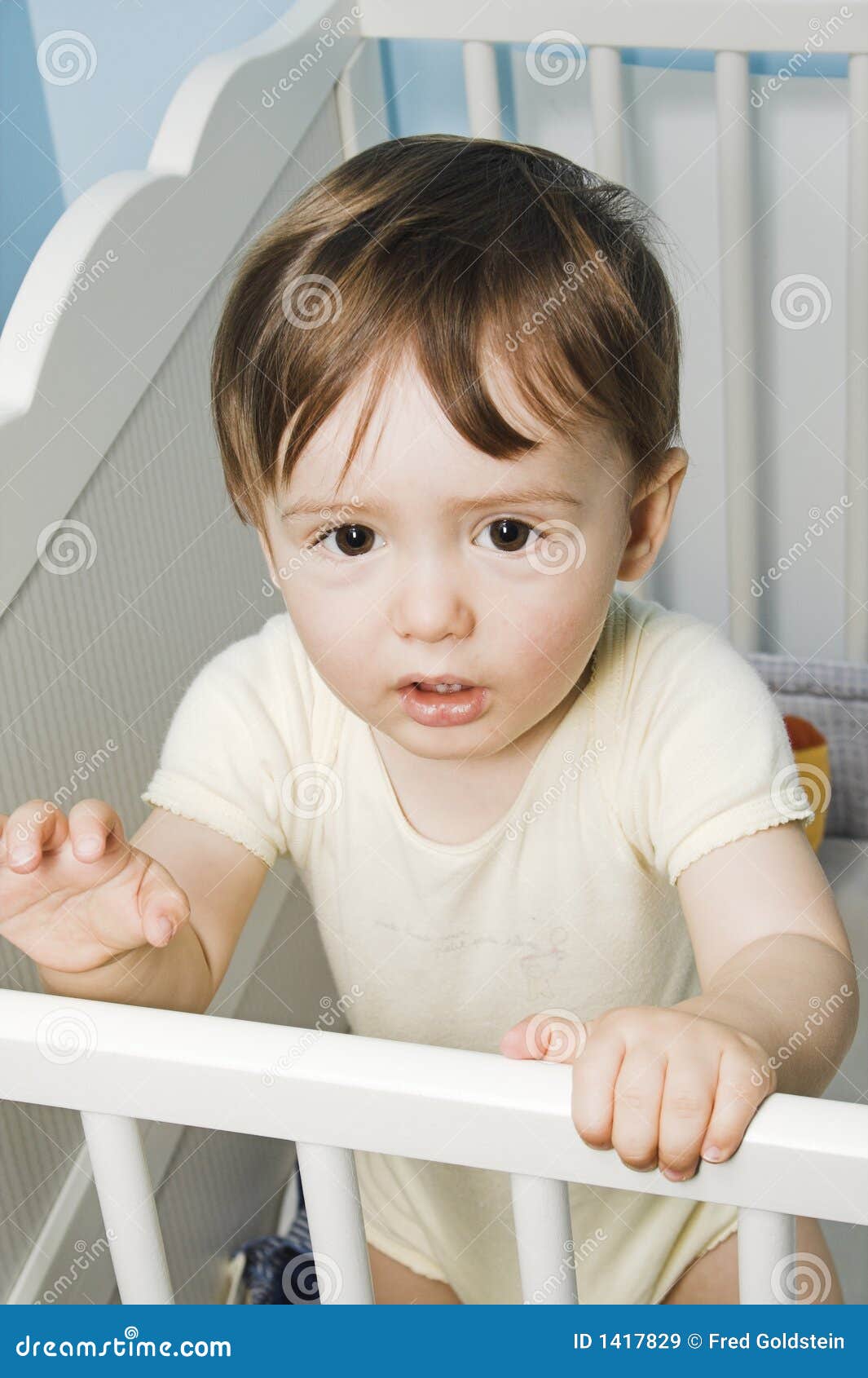 Baby standing in his crib stock image. Image of secure - 1417829
