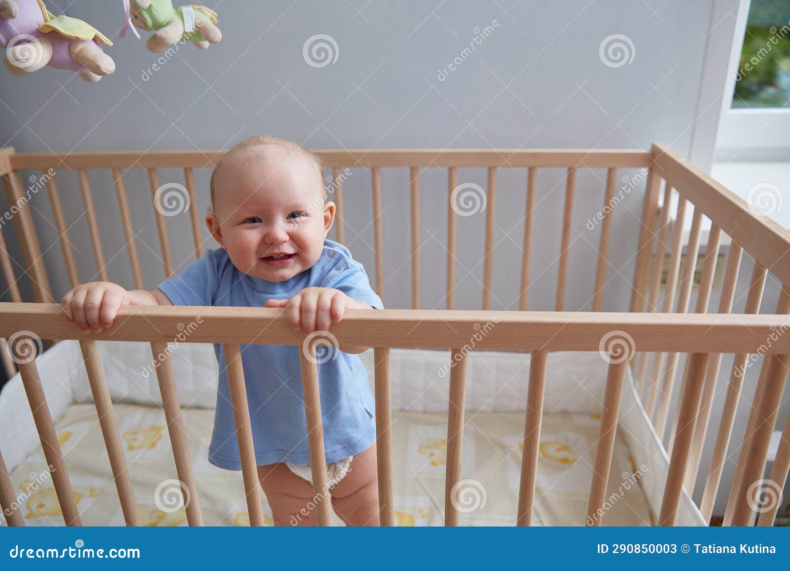 The Baby is Standing in His Crib Stock Image - Image of stand, laughing ...