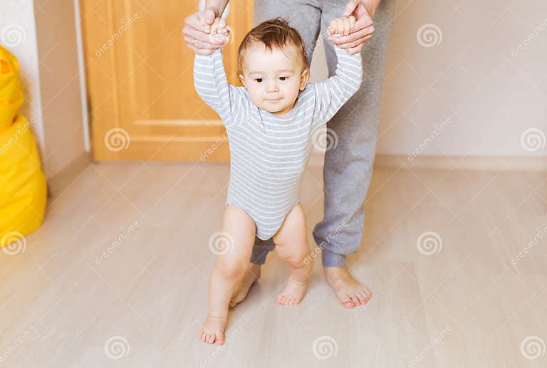 Baby Steps with the Help of His Mother Stock Photo - Image of help ...