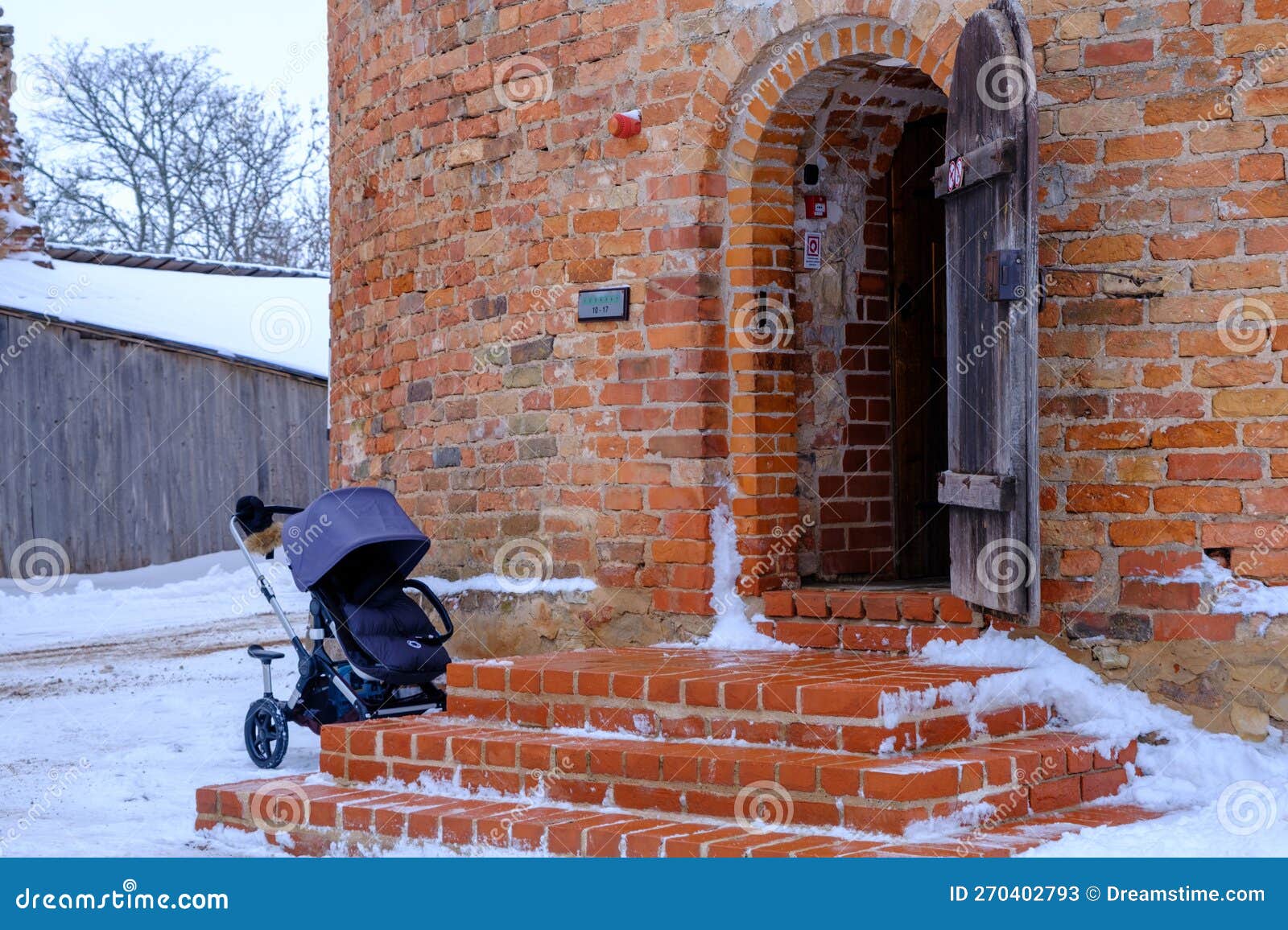 Baby Stroller at the Doors of the Castle. Red Brick Castle Stock Image ...