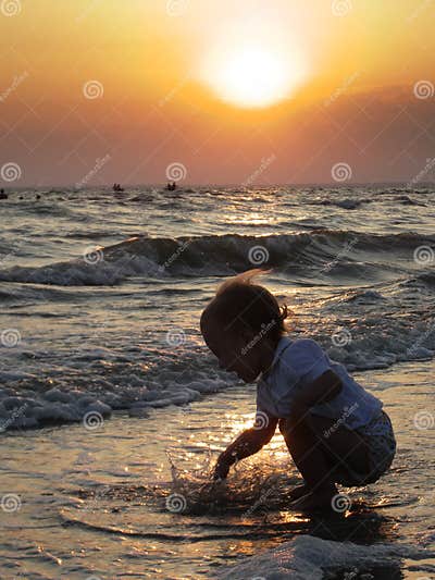 Baby on sunset beach stock photo. Image of figure, girl - 1162400