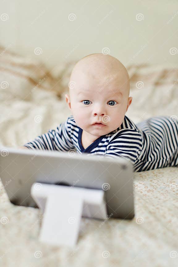 Baby with tablet pc stock image. Image of attention - 177716025