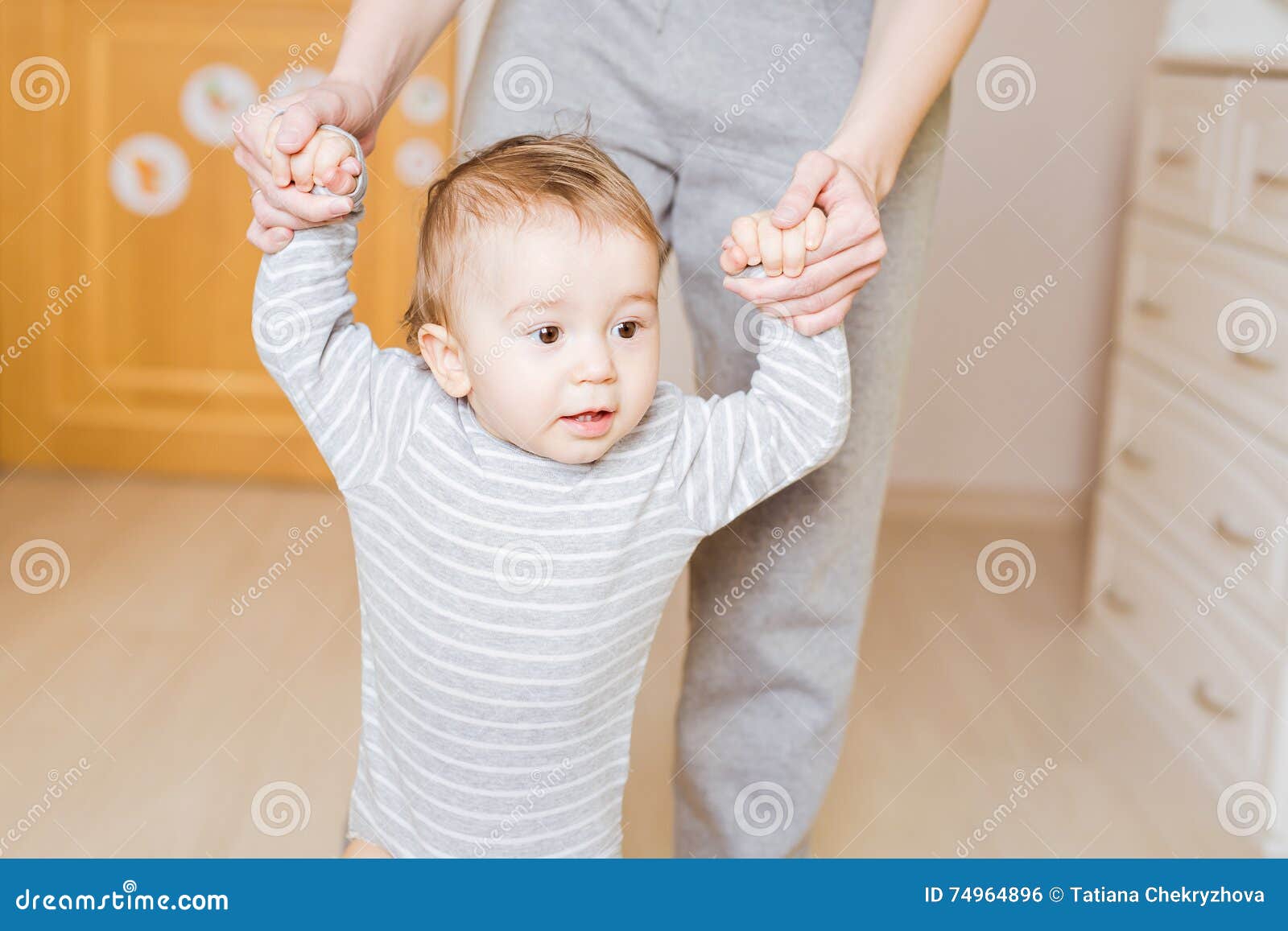 Baby Taking First Steps with Mother Help Stock Photo - Image of joyful ...