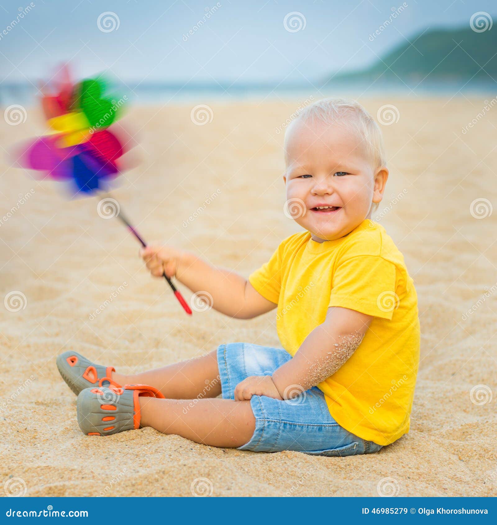 Baby with toy windmill stock image. Image of looking - 46985279