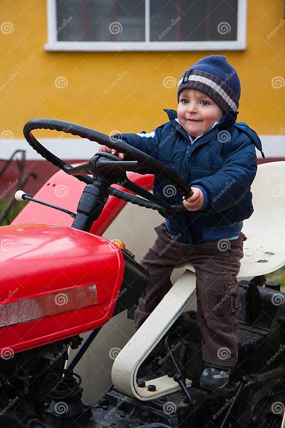 Baby on tractor old stock photo. Image of lawn, playful - 48605910