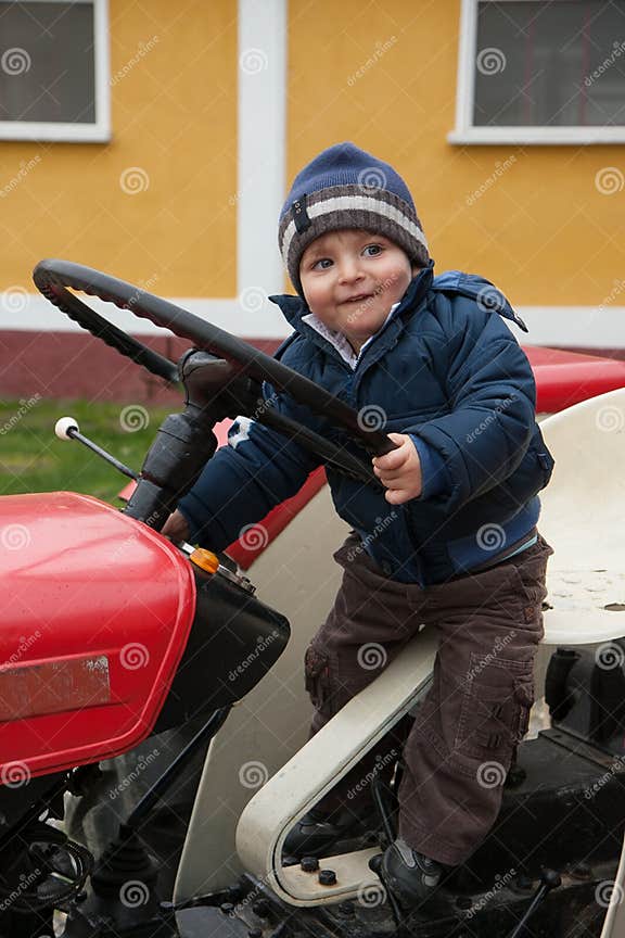 Baby on tractor old stock photo. Image of enjoyment, happy - 48605960