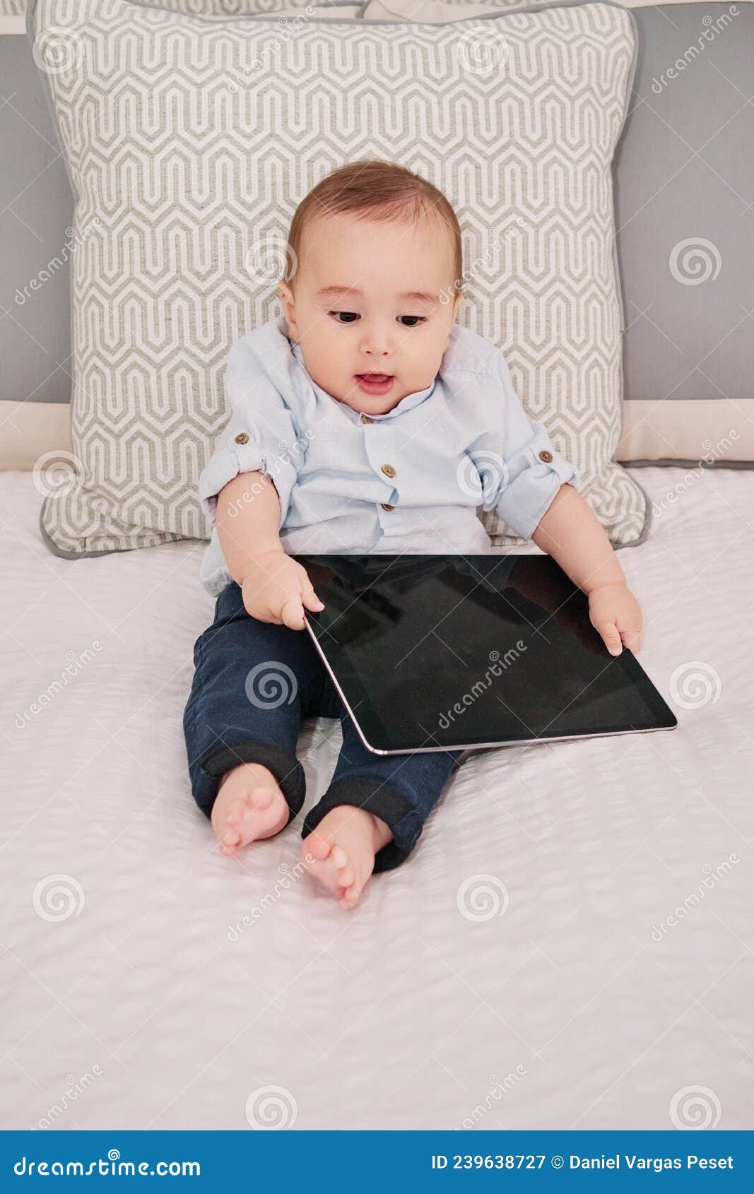 Baby Using a Tablet Sitting on the Bed Stock Image - Image of playing ...