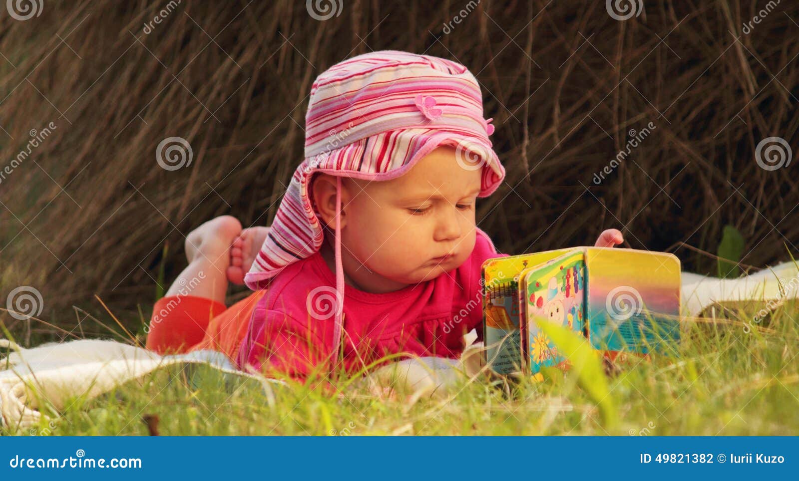 Baby is watching a book stock photo. Image of education - 49821382