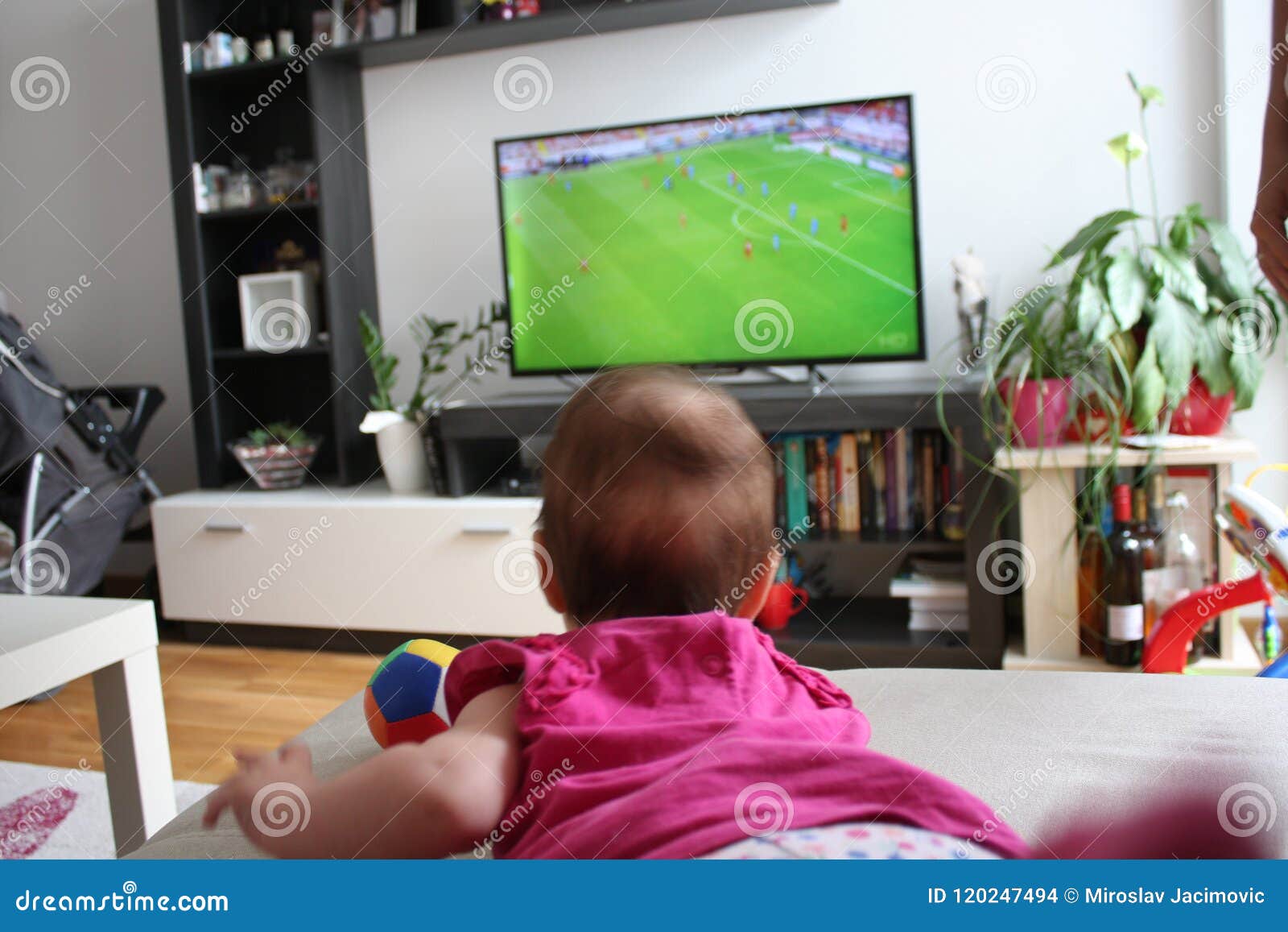Baby watching a soccer editorial stock image. Image of parent - 120247494