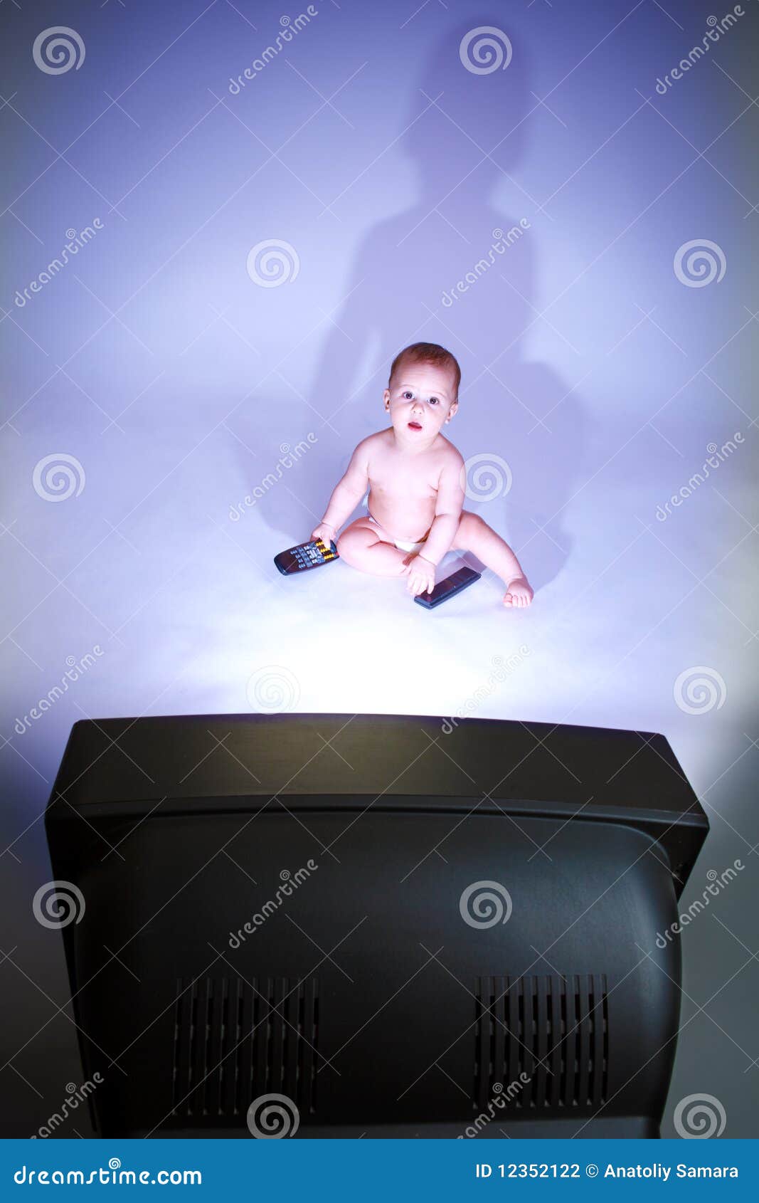 Baby watching TV stock photo. Image of lovely, baby, remote - 12352122