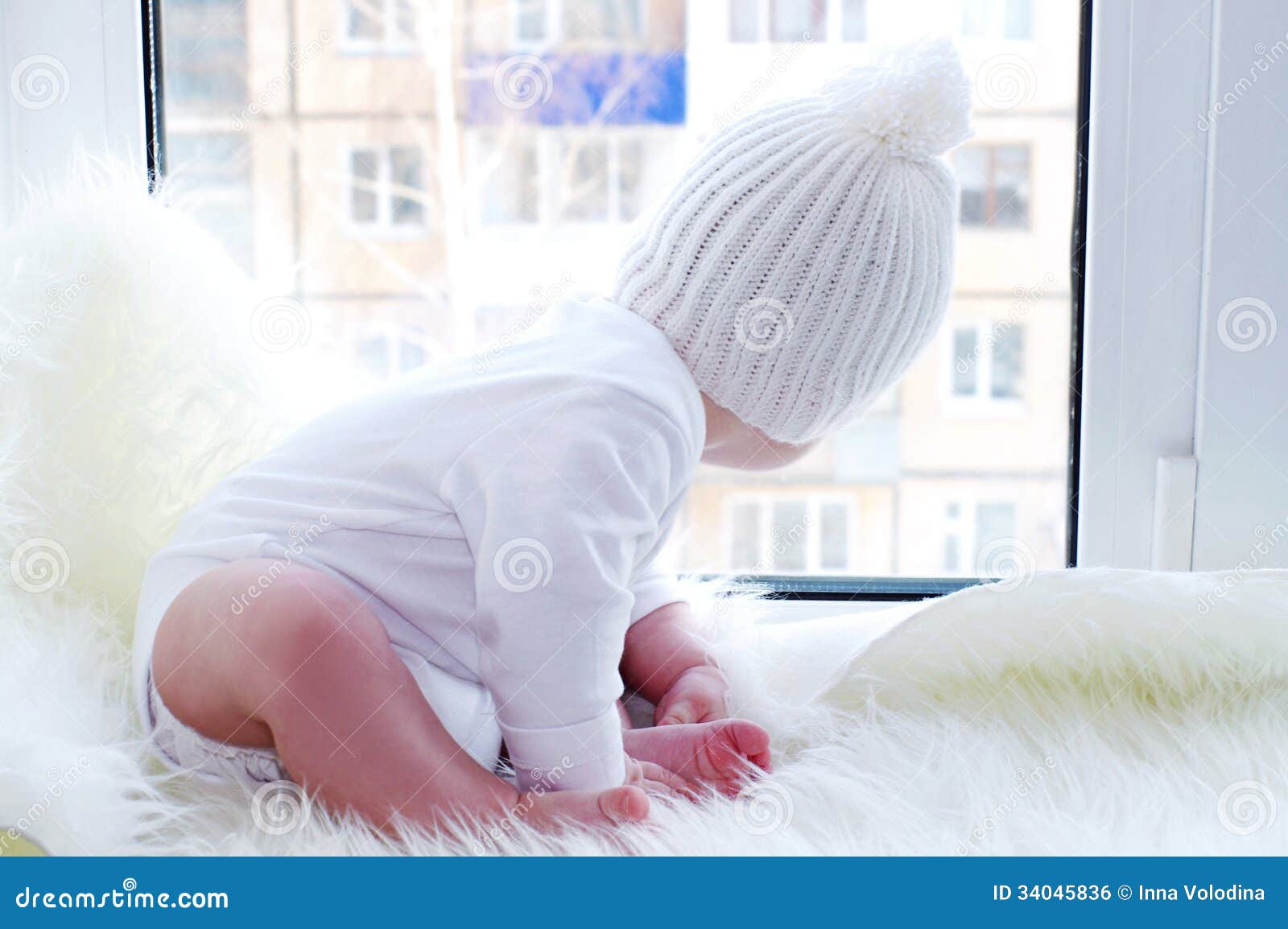 Baby in a White Hat Sits on a Window Sill Stock Photo - Image of ...