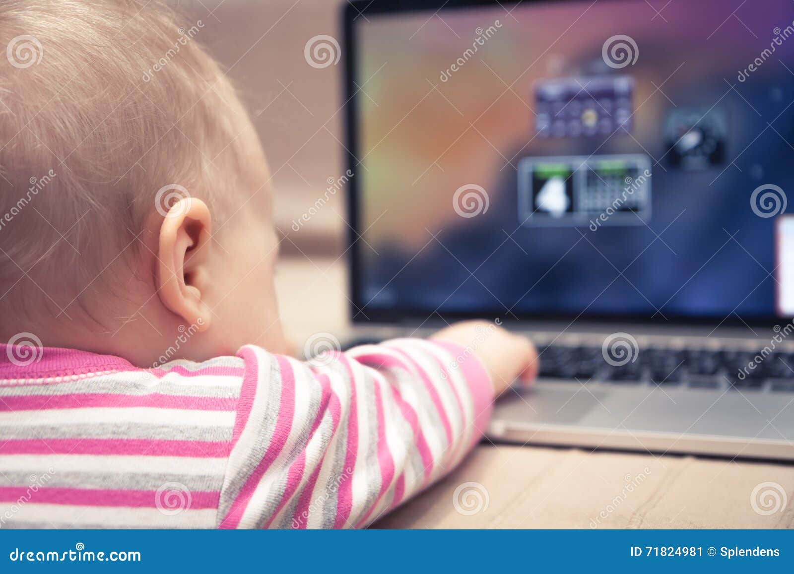 Baby Working on Laptop Computer with Hand Reaching To Touchpad Stock ...
