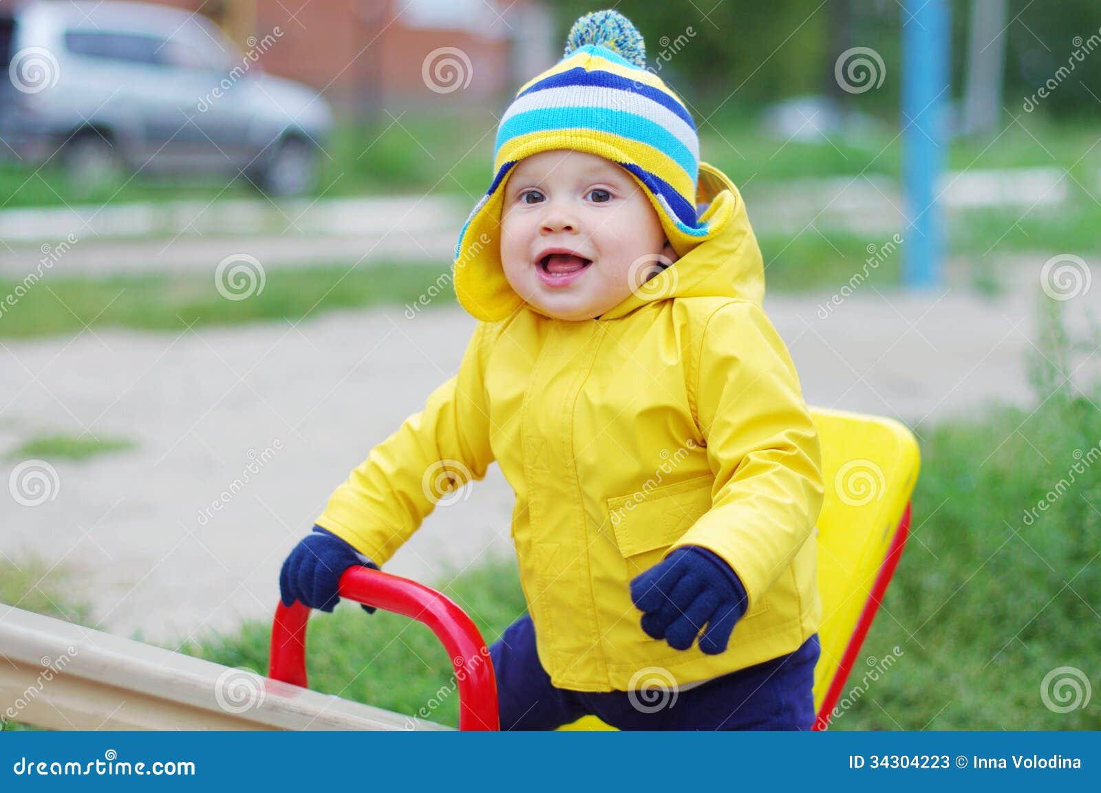 Baby in Yellow Jacket on Playground Stock Image - Image of happiness ...