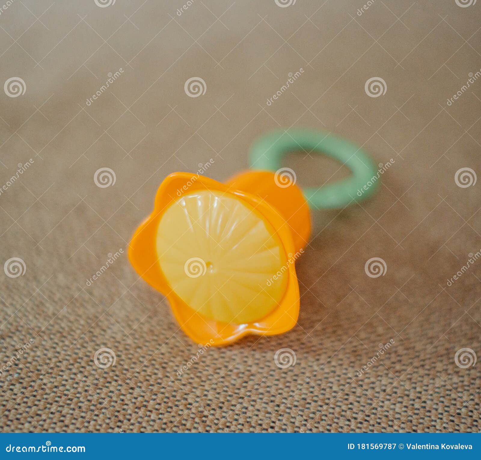 Baby Yellow Rattle Lies on the Fabric Stock Image - Image of yellow ...