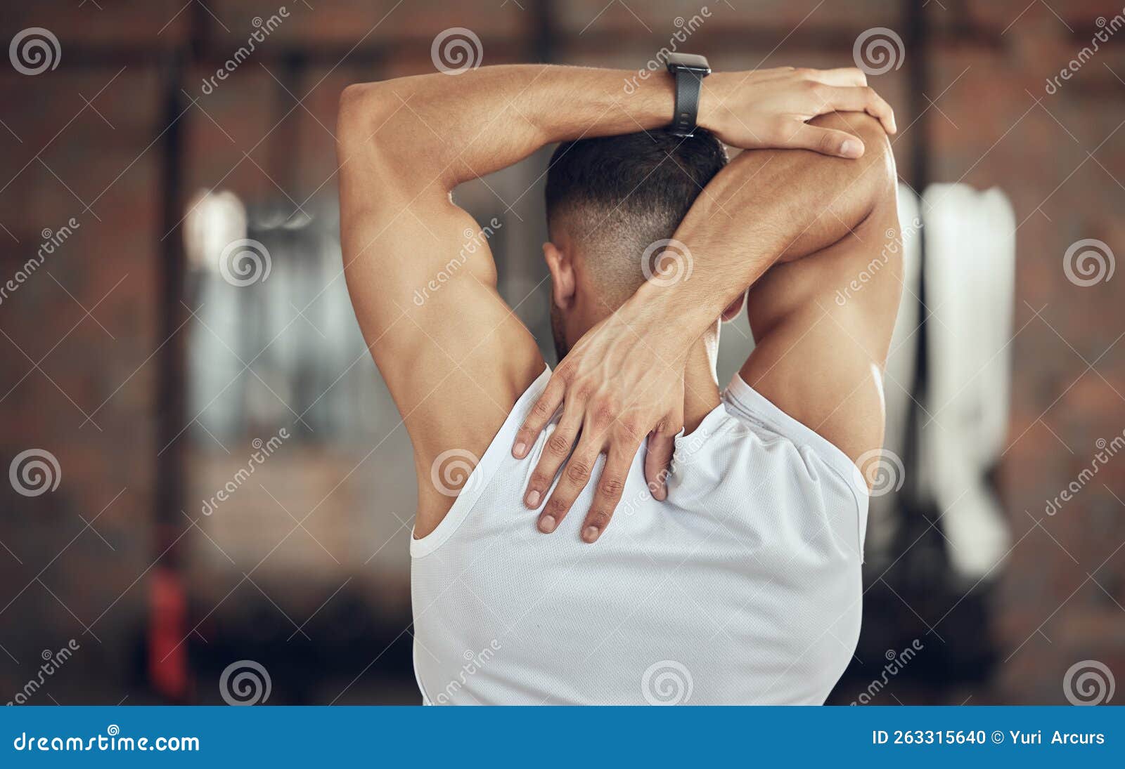 Back of a Bodybuilder Stretching before Exercise. Athlete Doing an Arm ...