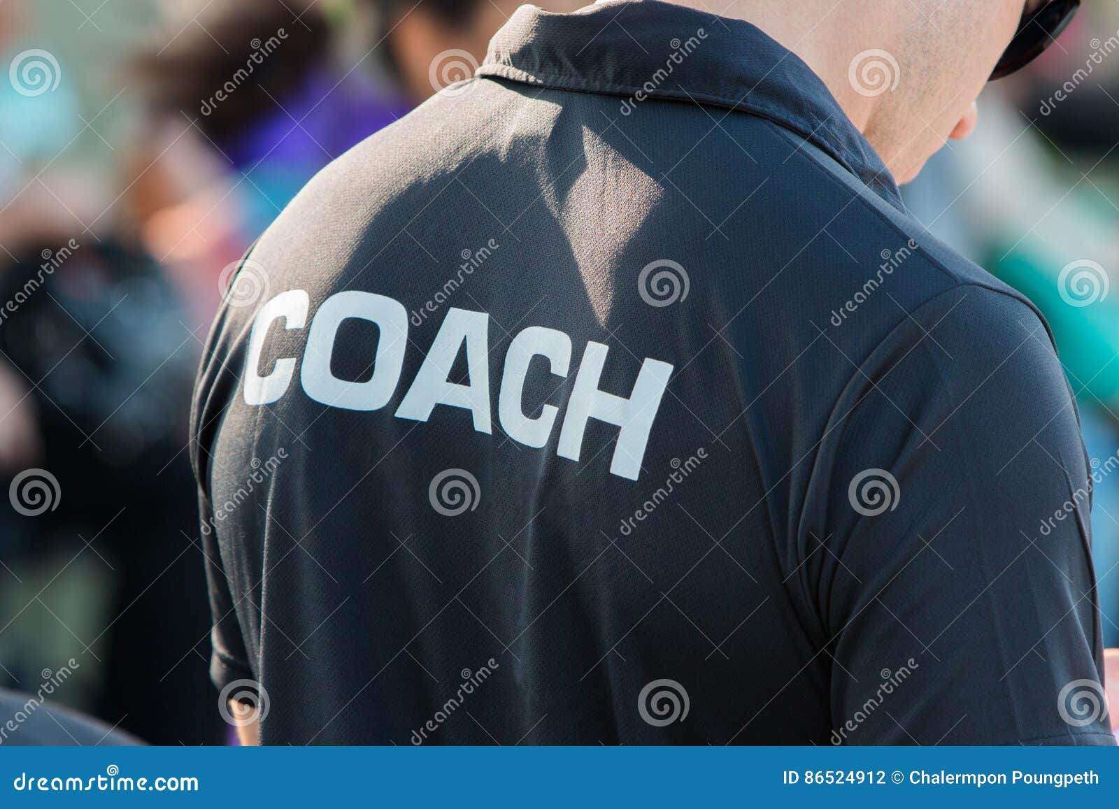 Back of a Coach`s Black Color Shirt with the Word Coach Written ...
