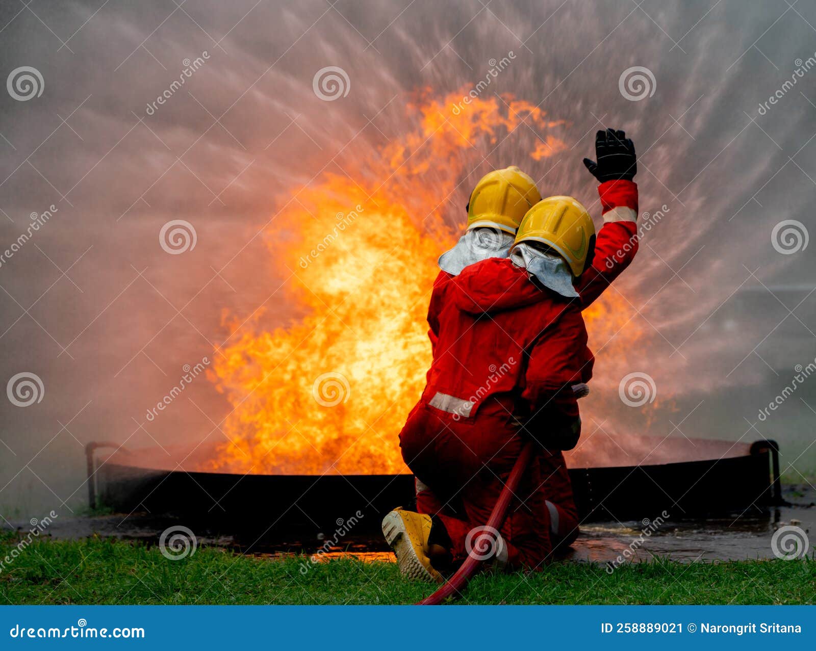 Back of Firefighter Team Support Together To Distinguish Fire Using ...