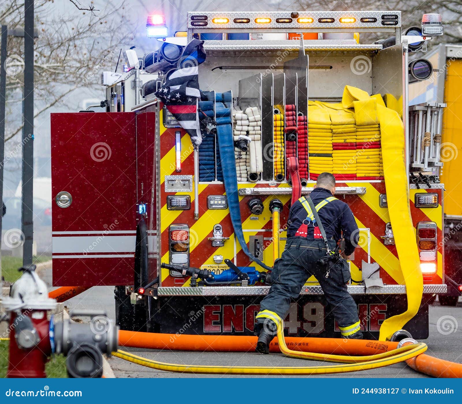 Back of the Firetruck with Firefighter and Equipment Editorial ...