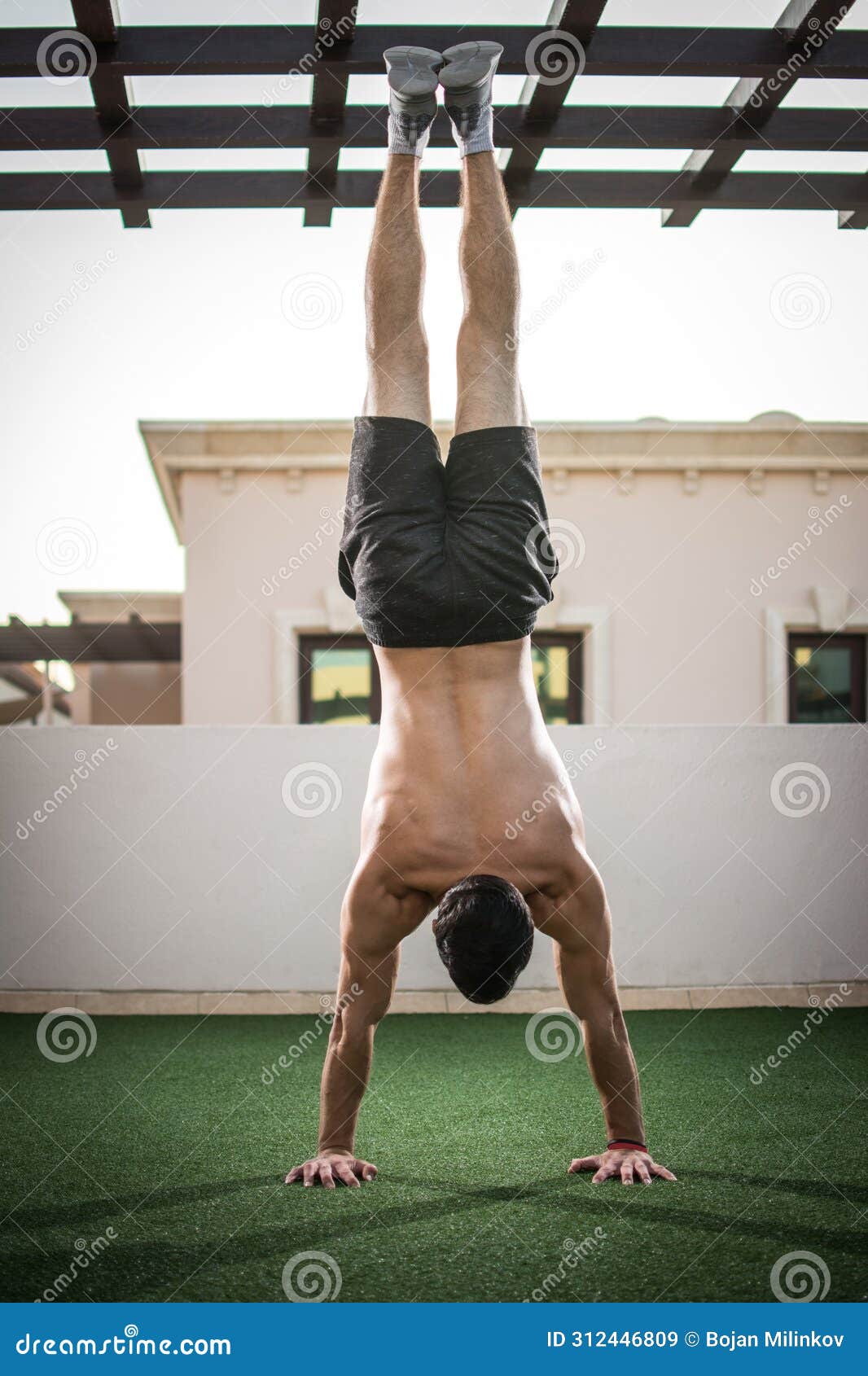 Back of Handsome Shirtless Man Doing Handstand Exercise Outdoors Stock ...