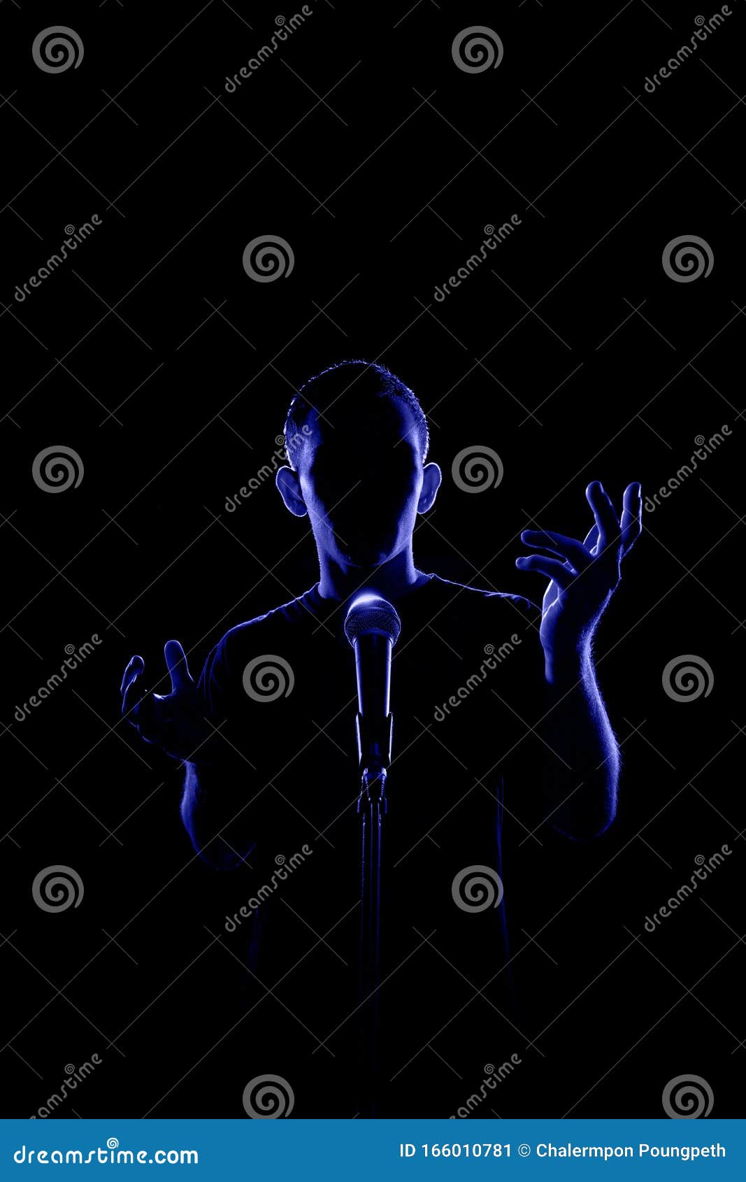 Back Lit View of a Faceless Man Talking or Singing To a Microphone ...
