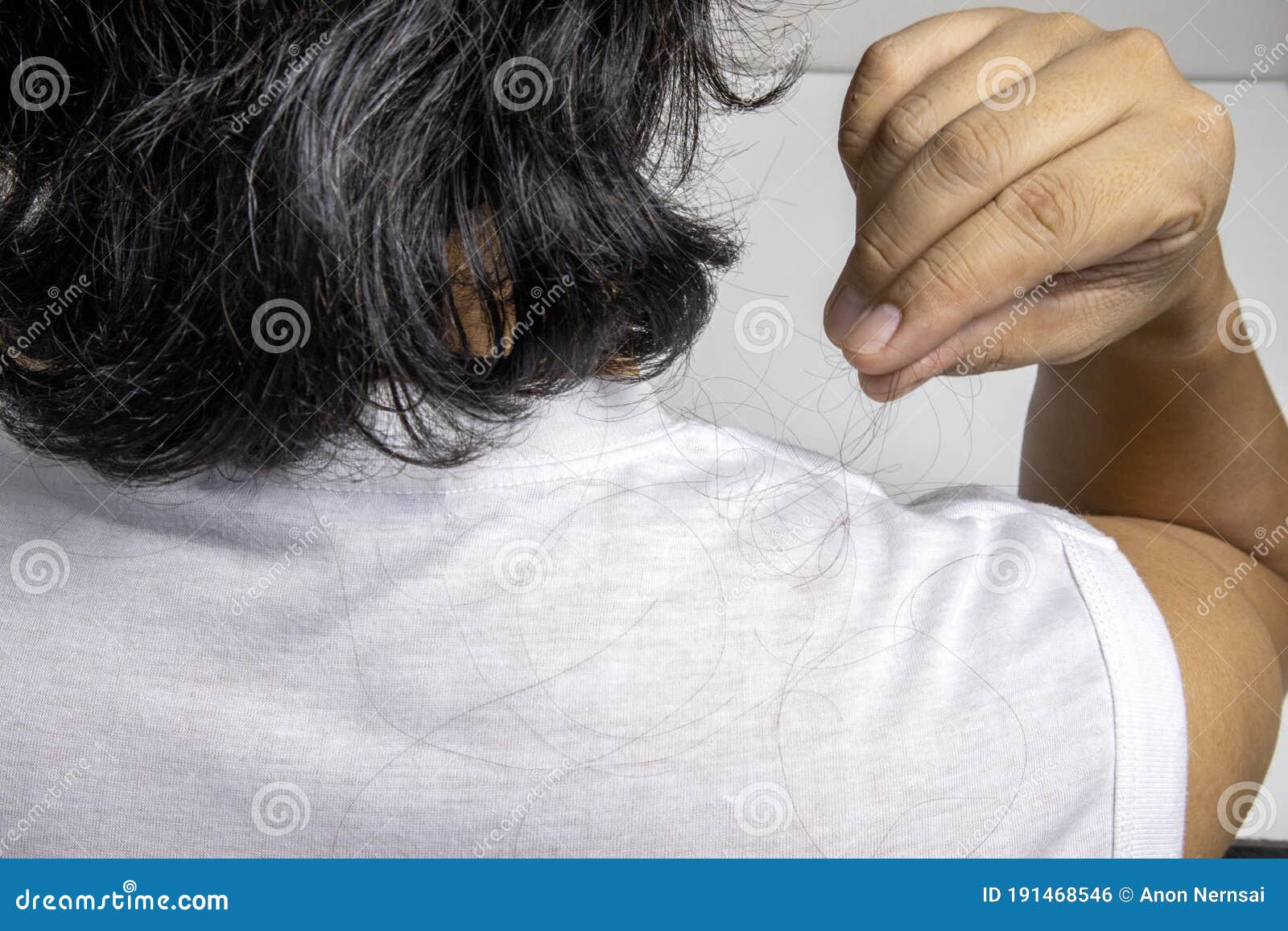 Man Picks Up the Hair that Has Fallen on His Shoulders. Stock Photo ...