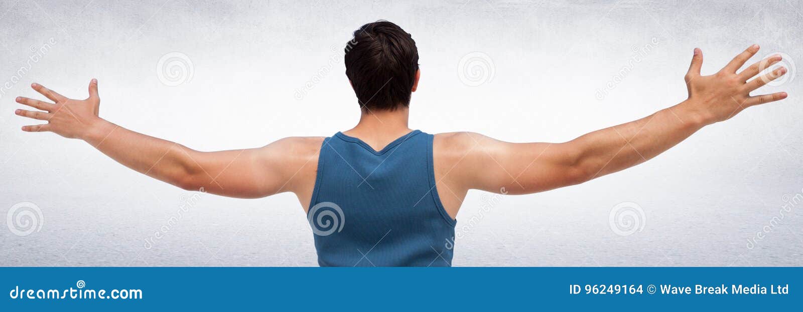 Back of Man in Training Gear with Arms Out Against White Wall Stock ...