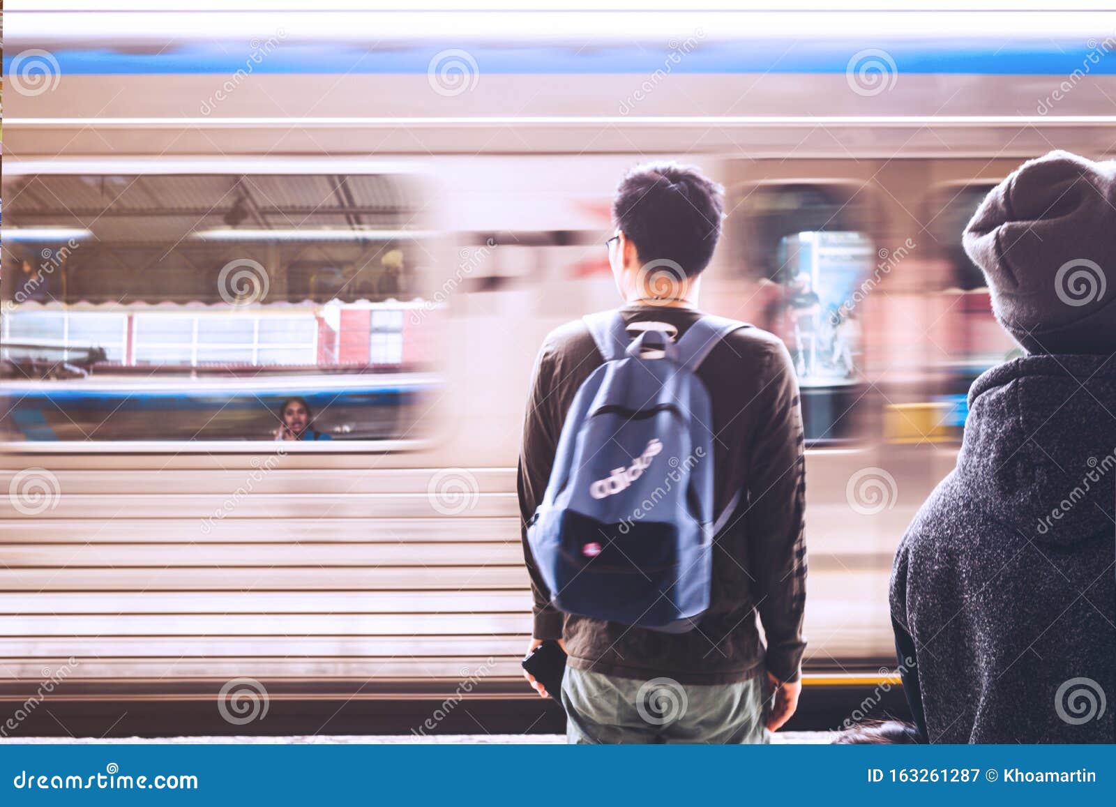 Back of a Man Waiting for the Train Under the Sunlight at Station in ...