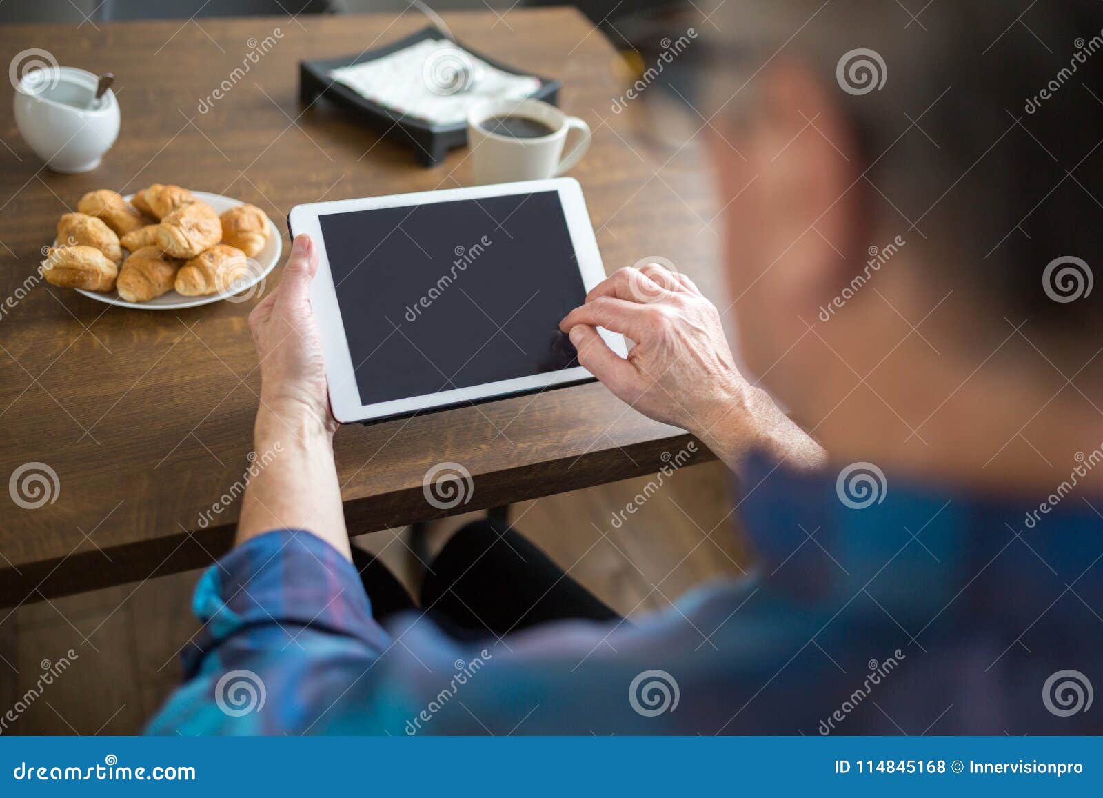 Senior Man Holding Tablet at Kitchen Table Stock Photo - Image of ...