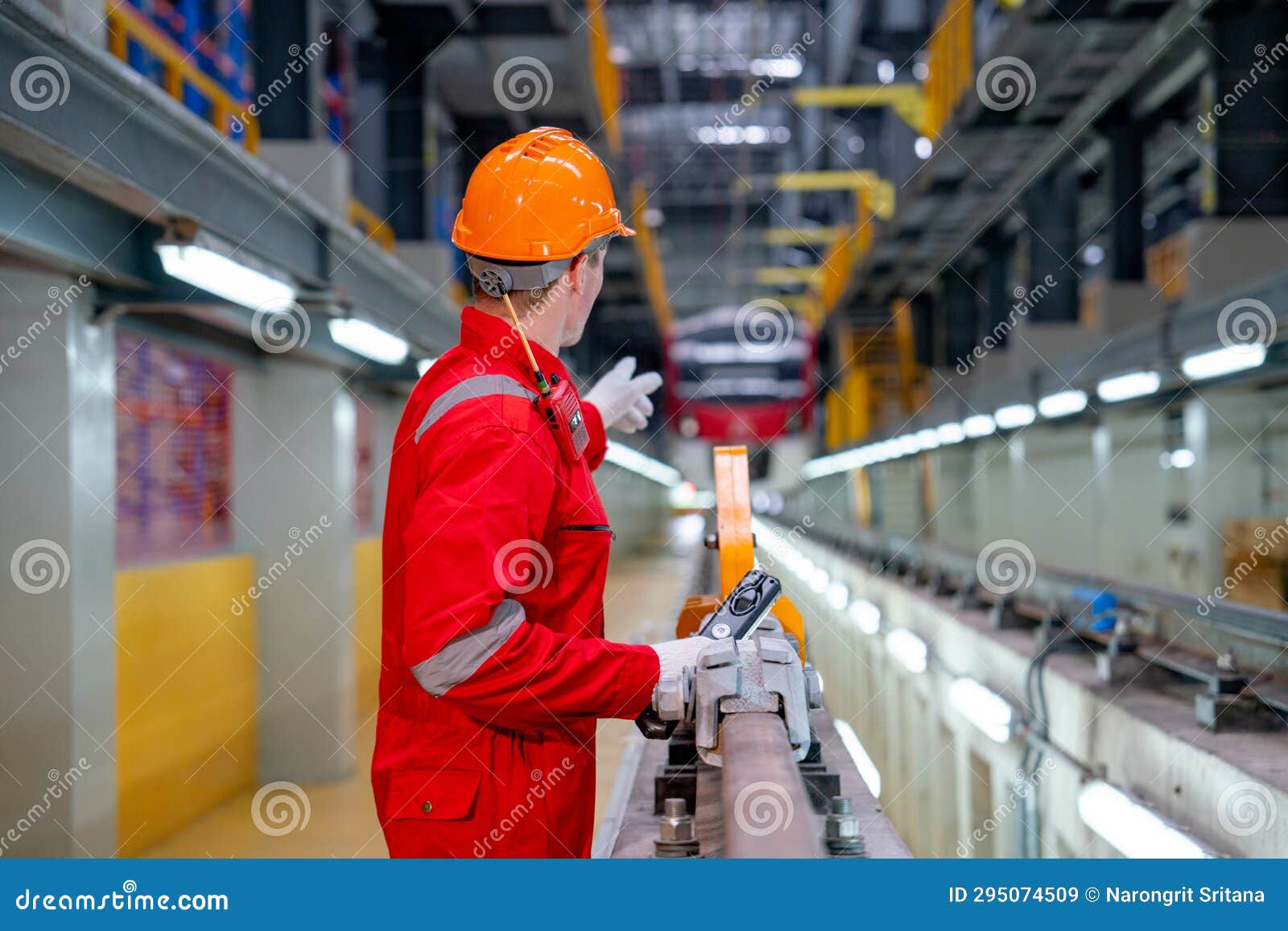 Back of Professional Technician Worker with Safety Uniform Point To the ...