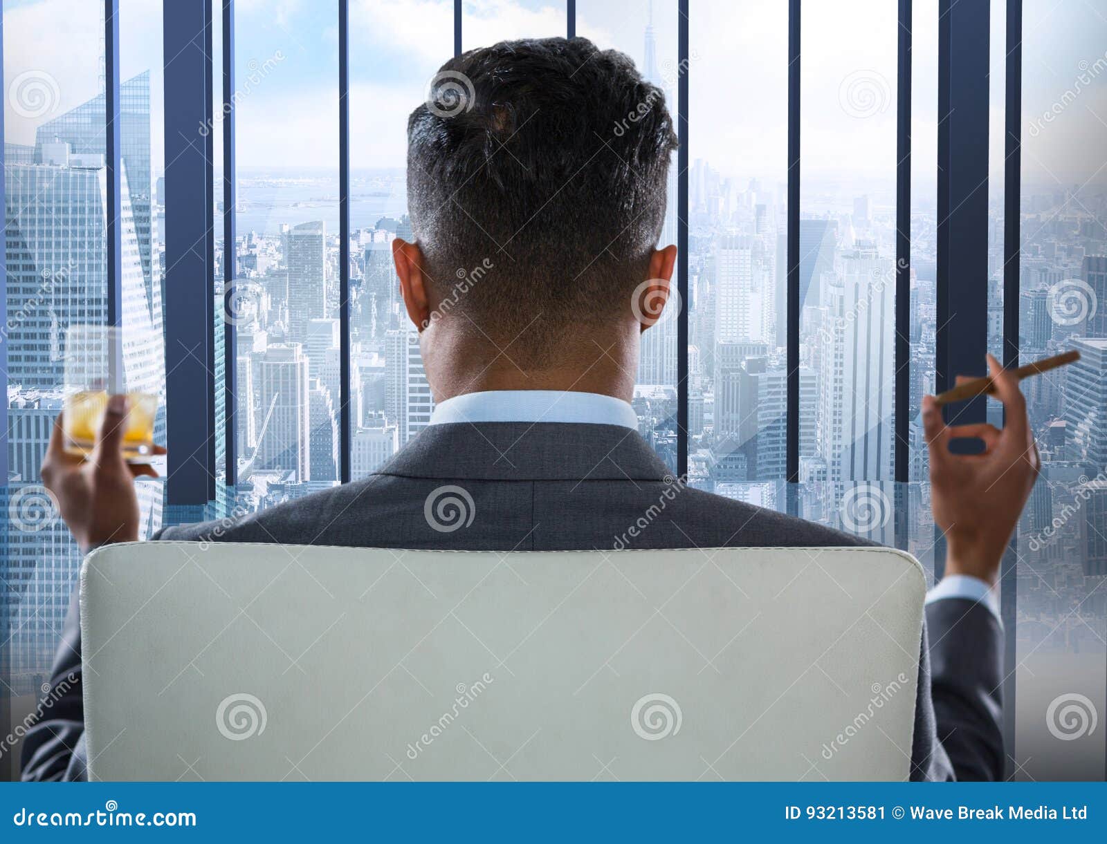 Back of Seated Business Man Smoking Cigar and Drinking while Looking at ...